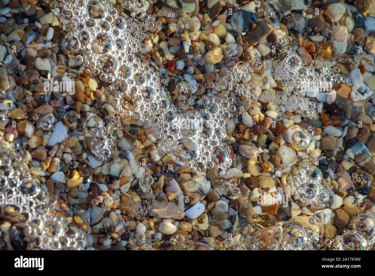 sea pebbles colored granite on the beach background stones. The shore ...