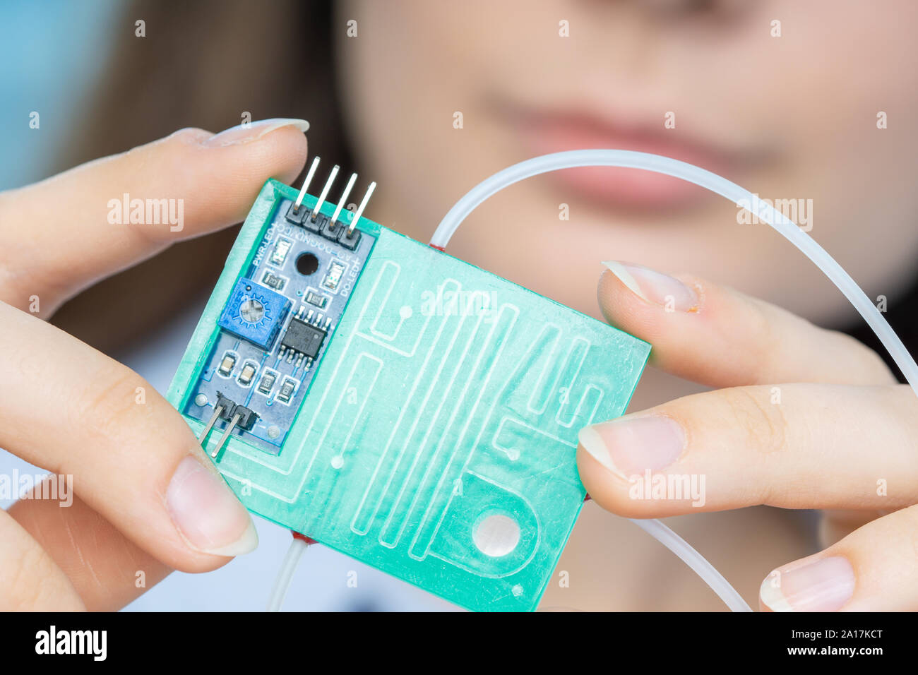 Young scientist woman in microbiological lab with lab-on-chip LOC ...