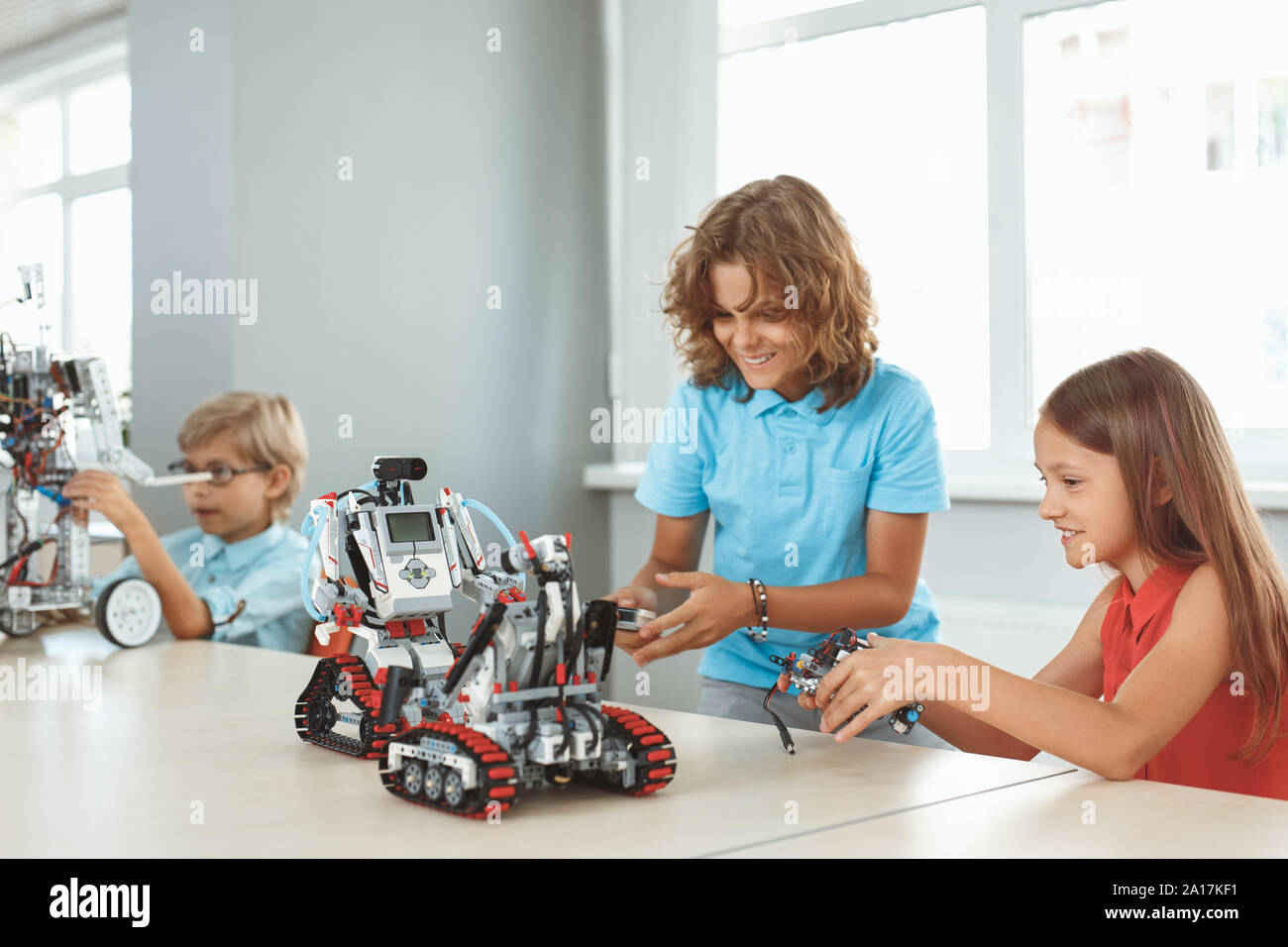 Robotics. Children having class playing robots fight smiling excited ...
