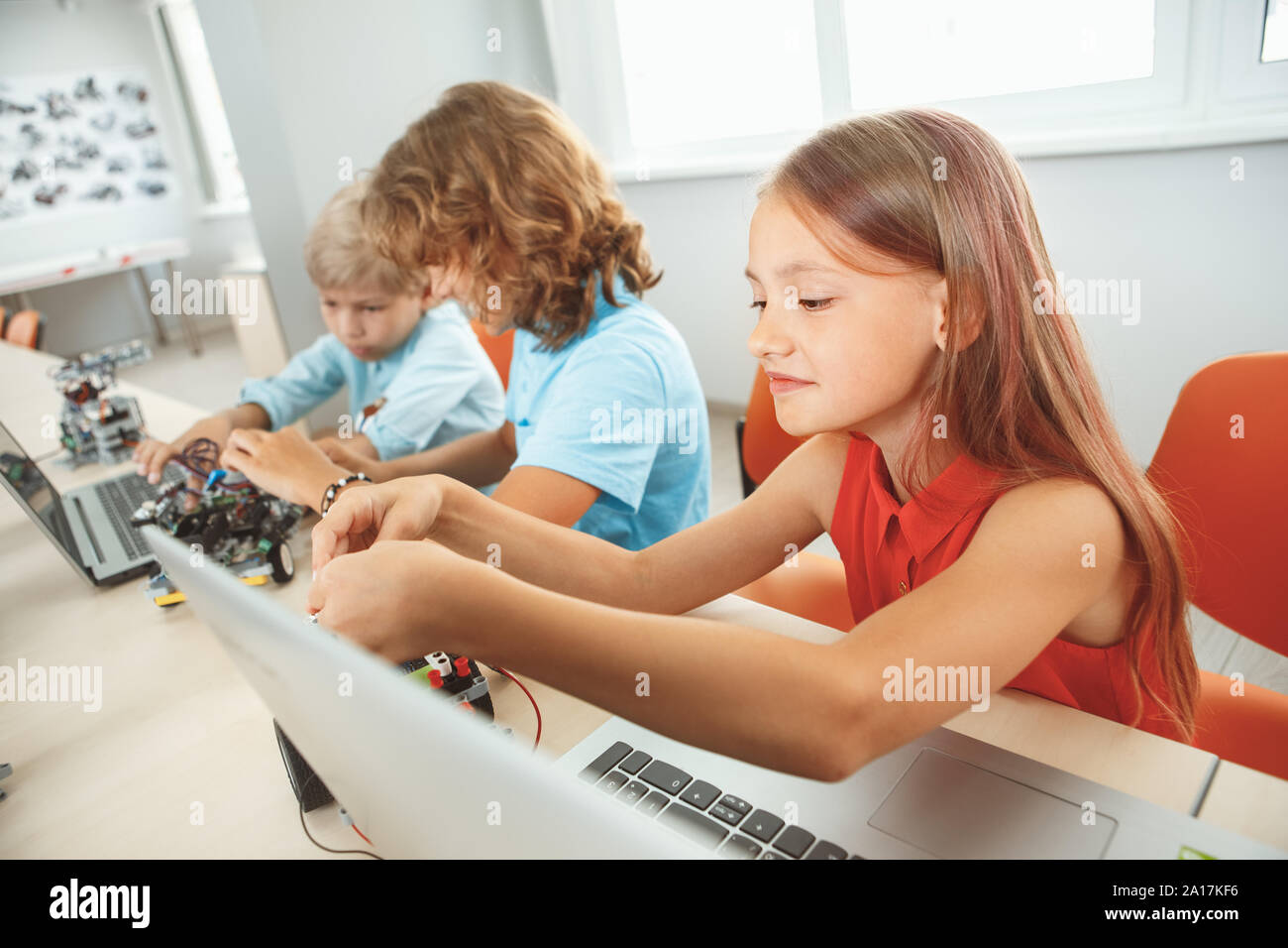 Robotics. Children having class making robots girl with wires smiling ...