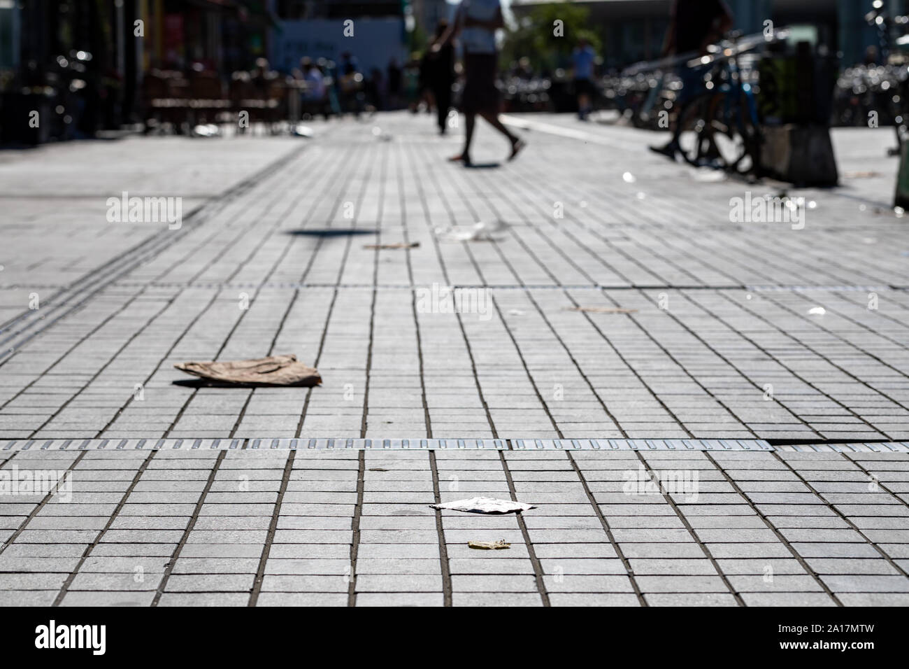 Pieces of litter on the ground in a public square Stock Photo - Alamy