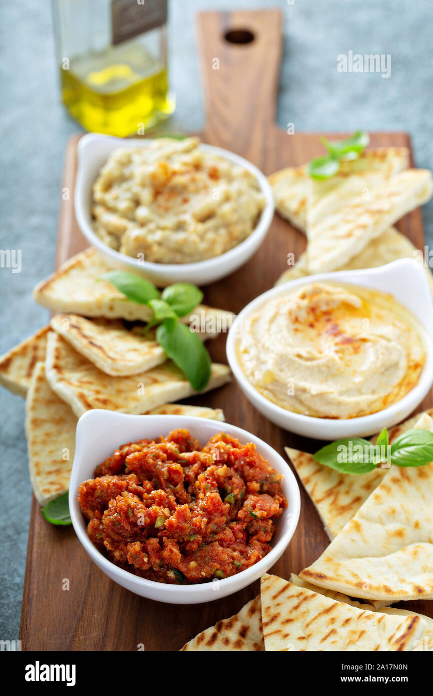Mediterranean mezze board with pita and spicy tomato dip Stock Photo ...