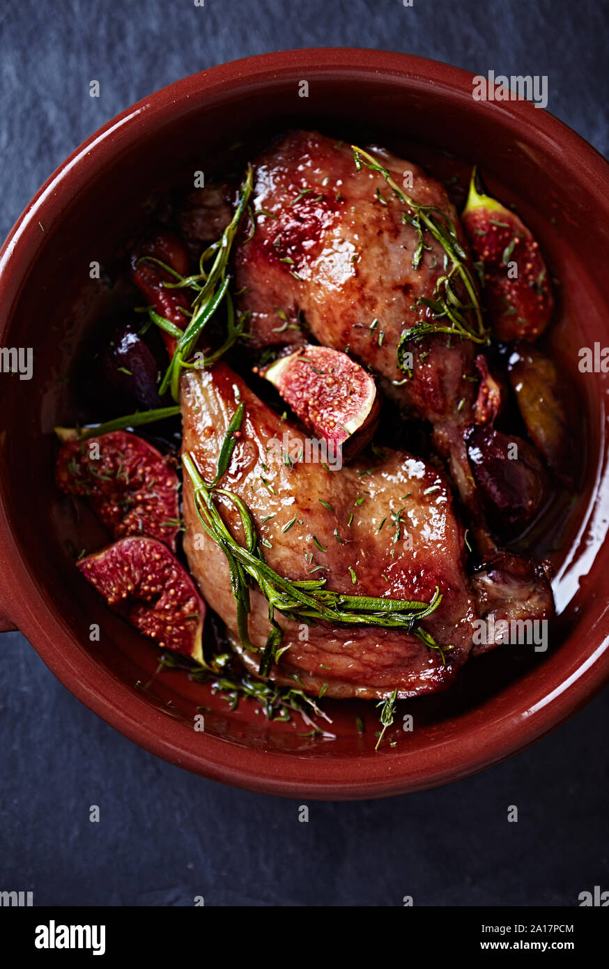 Oven-baked duck legs with figs and rosemary Stock Photo - Alamy