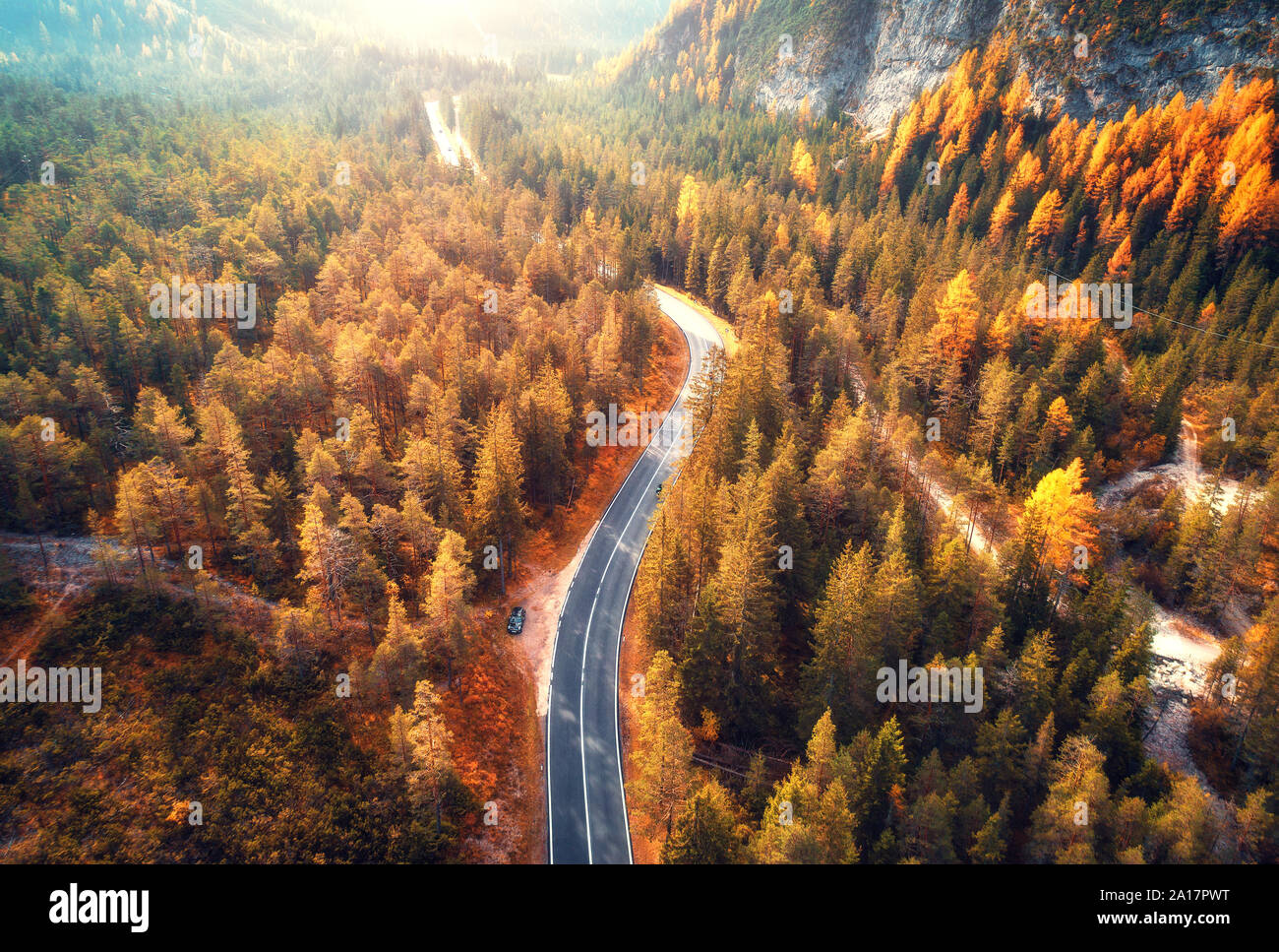 Aerial view of the road in beautiful autumn forest at sunset Stock ...