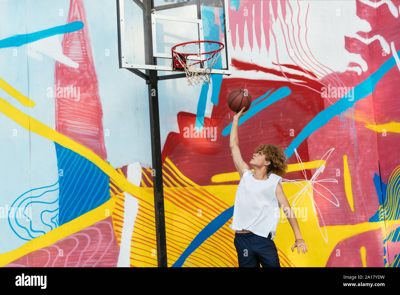 Teen boy shooting basketball hi-res stock photography and images - Alamy