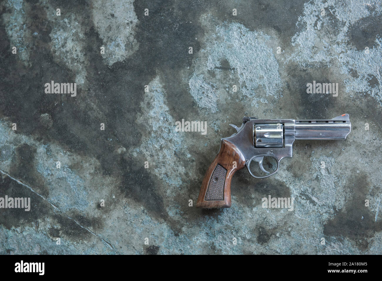 Revolver on a musty ground Stock Photo - Alamy