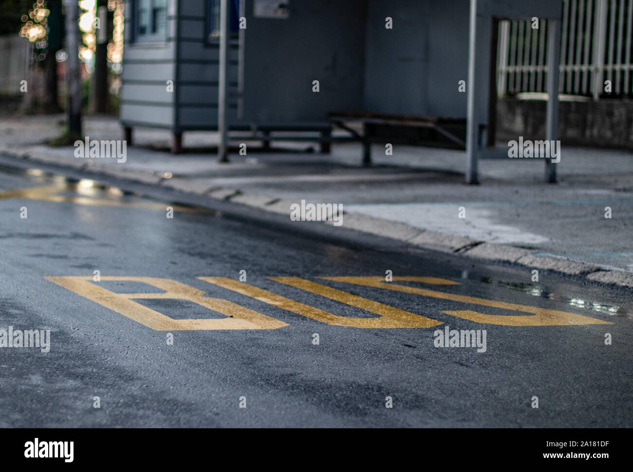Bus sign on the street in front of a bus stop Stock Photo - Alamy