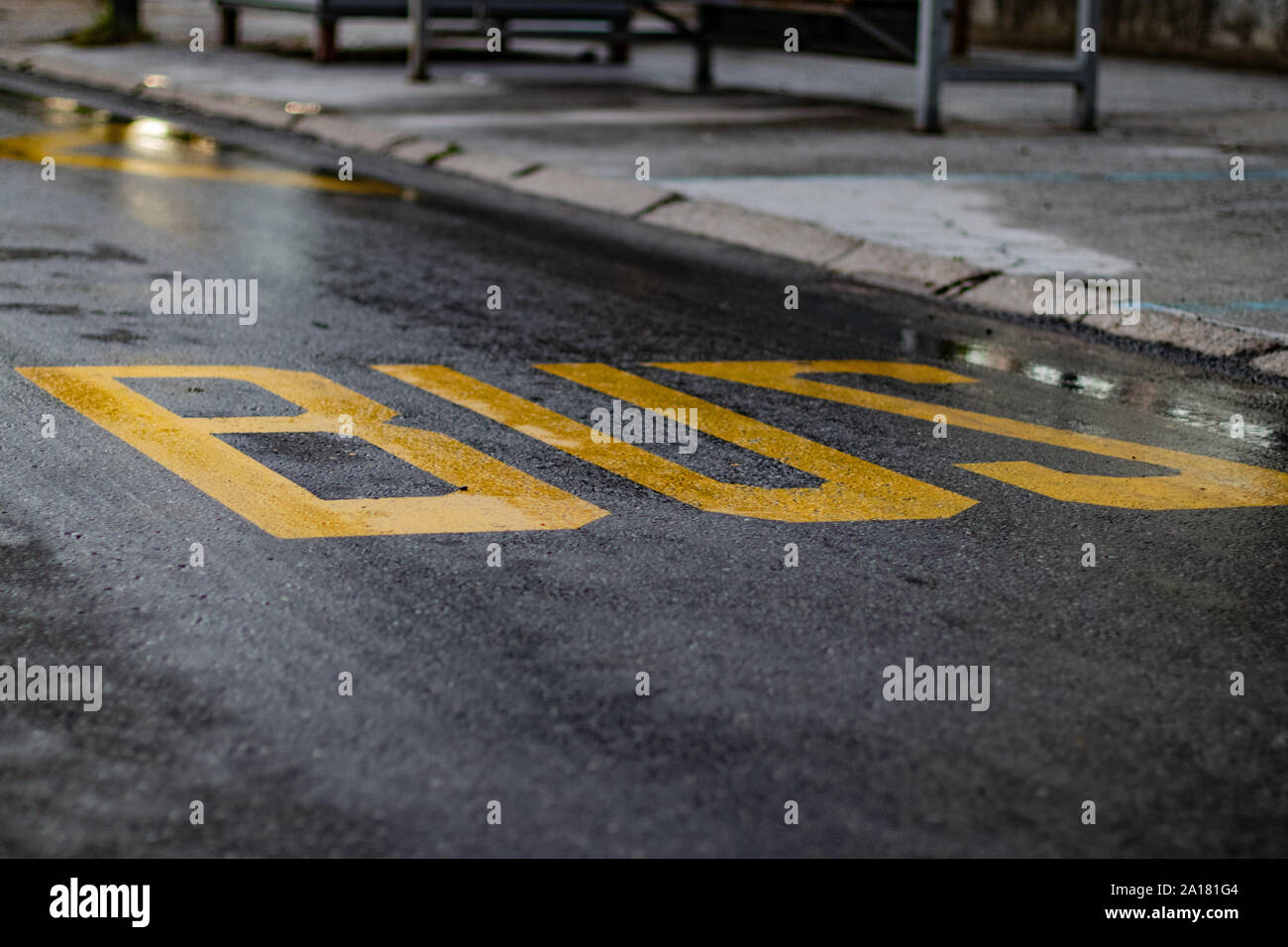 Bus sign on the street in front of a bus stop Stock Photo - Alamy