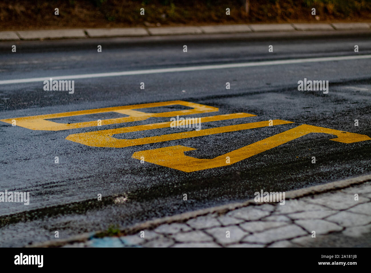 Bus sign on the street in front of a bus stop Stock Photo - Alamy
