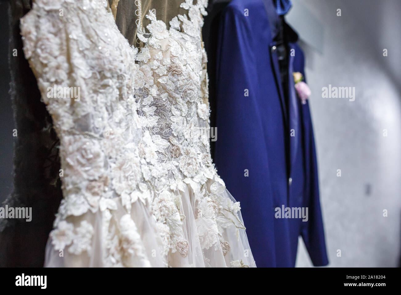 blue suit of the groom and white dress of the bride Stock Photo - Alamy