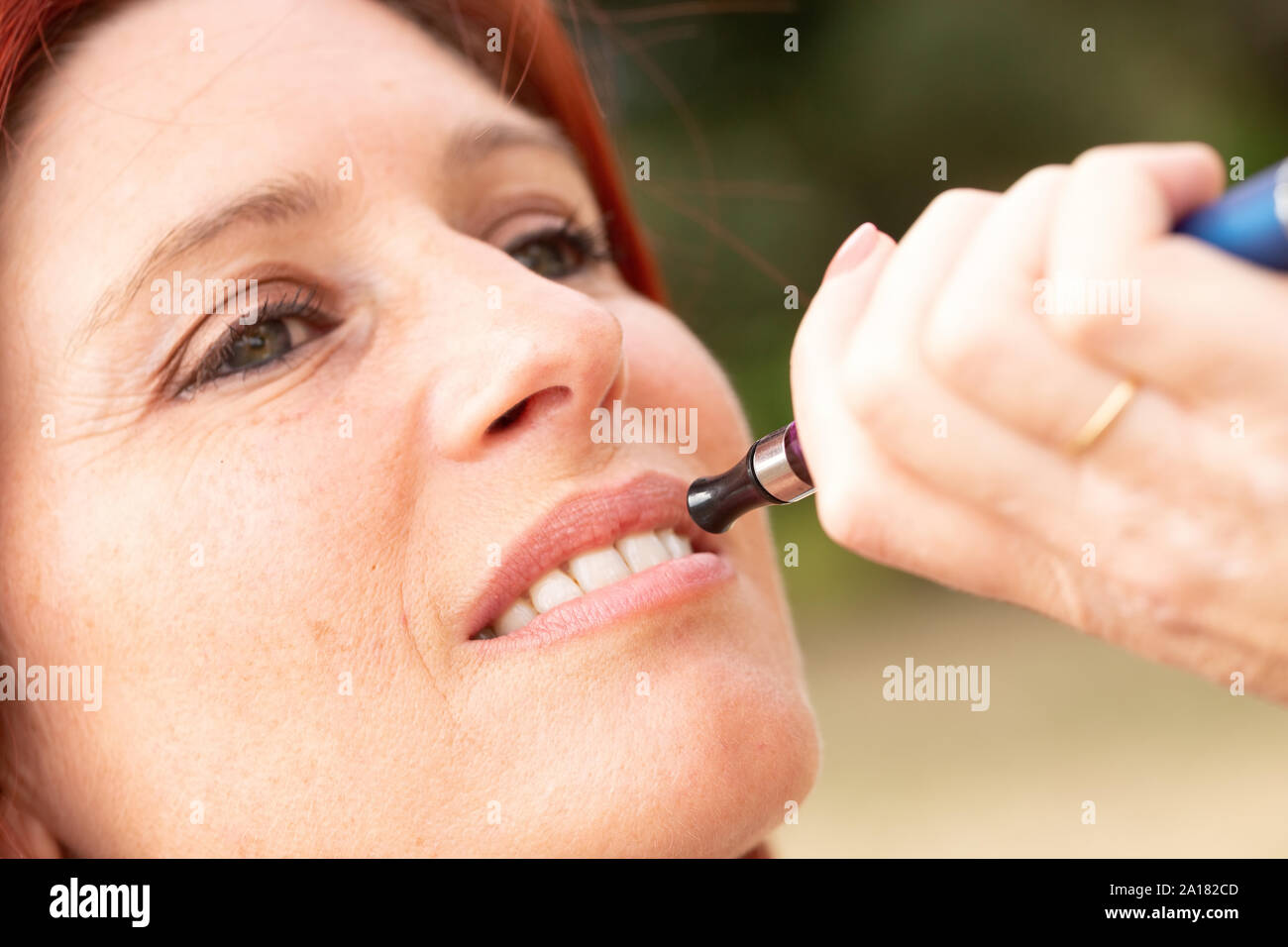 Portrait Of A Pretty Redhead Woman Smoking A Electronic Cigarette In A 4035