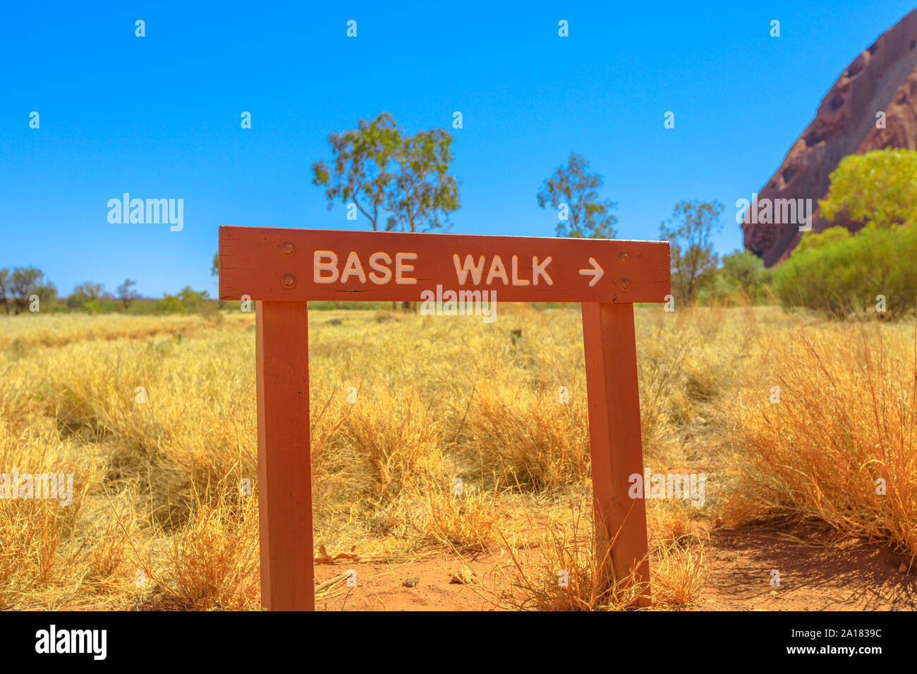 Uluru Base Walk sign in sand path of Uluru-Kata Tjuta National Park ...