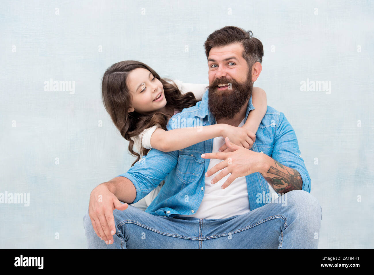 Honoring fathers and celebrating fatherhood. Little daughter hugging father on fathers day ...