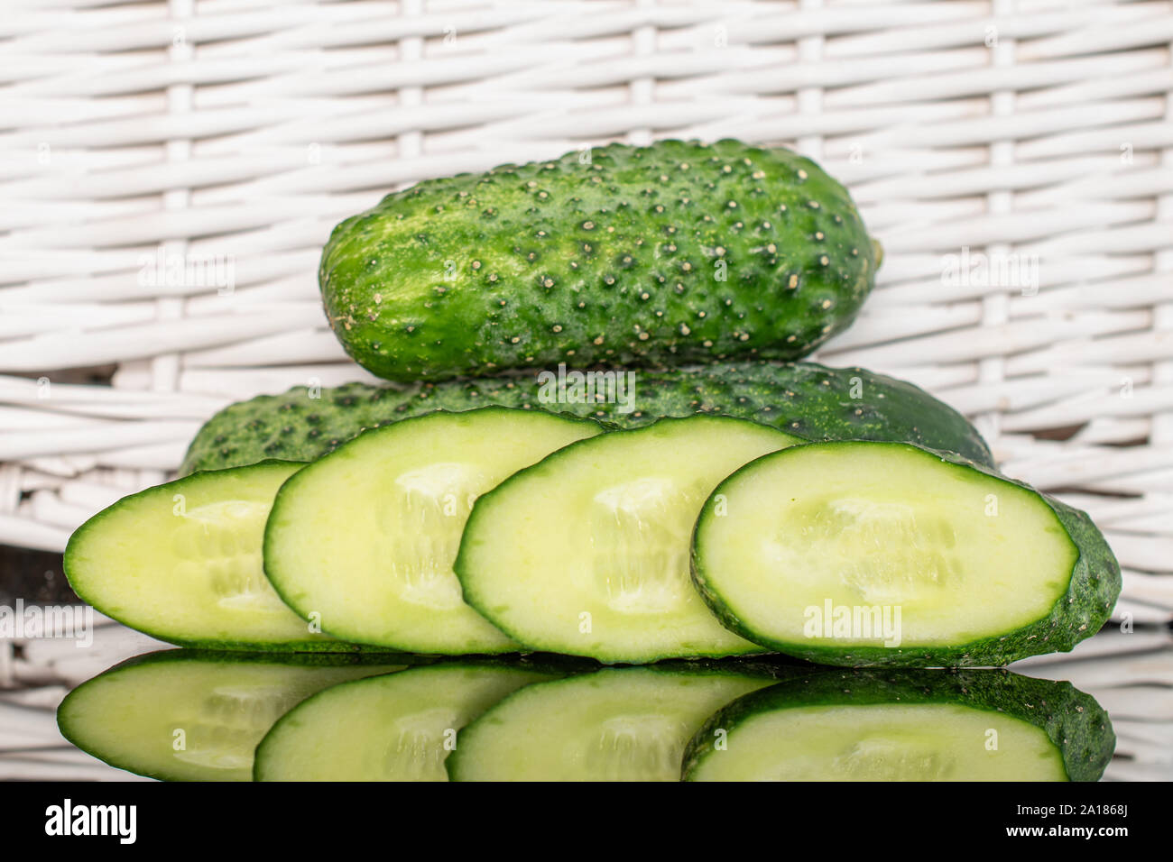 Group of two whole four slices of fresh pickling cucumber with braided ...