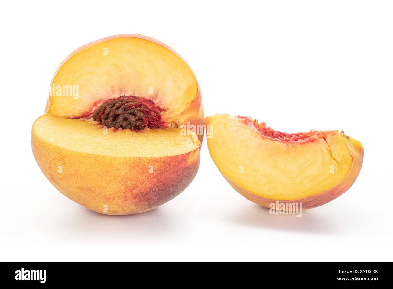 One fresh fuzzy peach with separated slice isolated on white background ...
