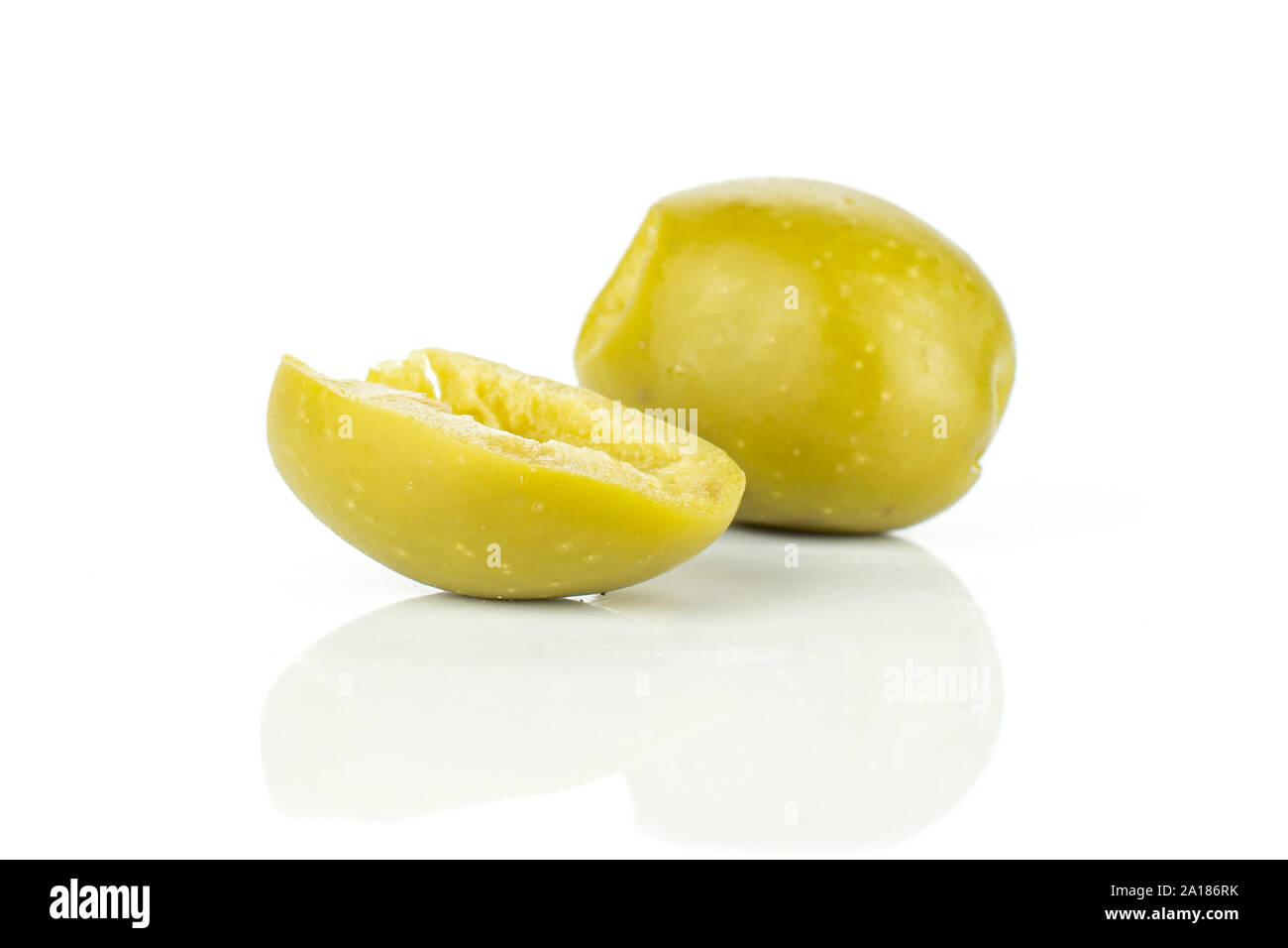 Group of one whole one half of pitted green olive isolated on white ...