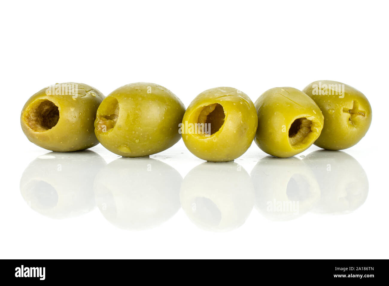 Group of five whole pitted green olive isolated on white background ...