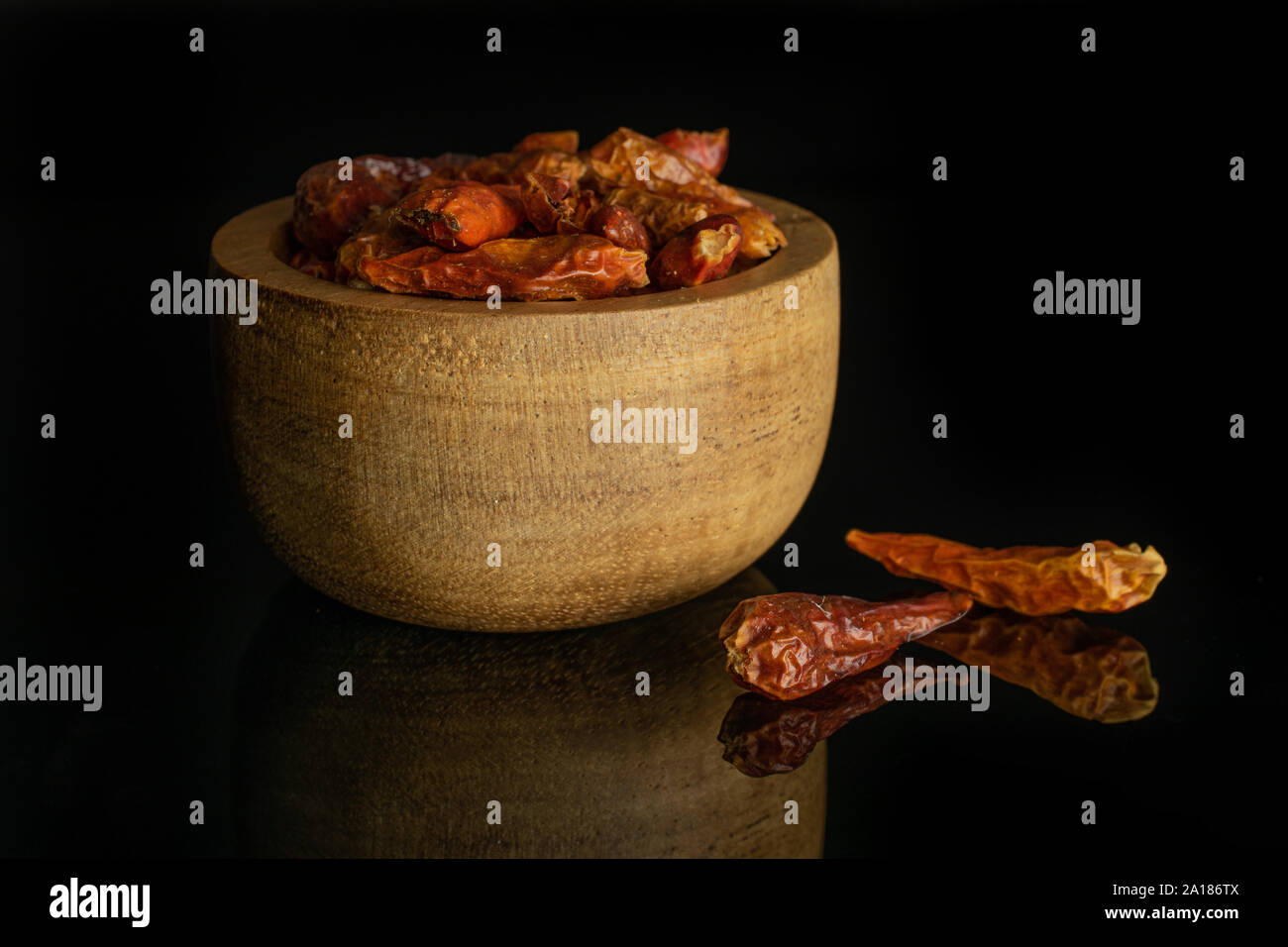 Lot of whole hot dry red chili pepper peperoncino in wooden bowl ...