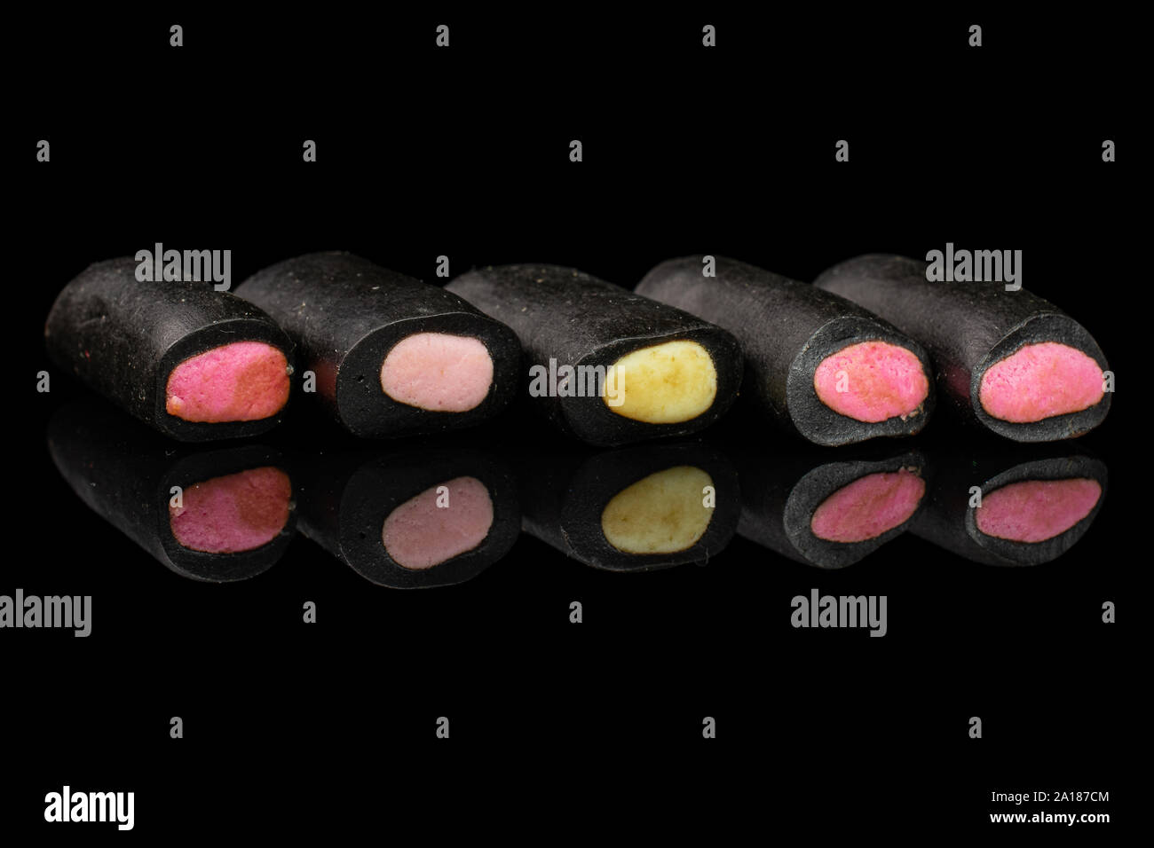 Group of five whole sweet black liquorice candy in row isolated on ...