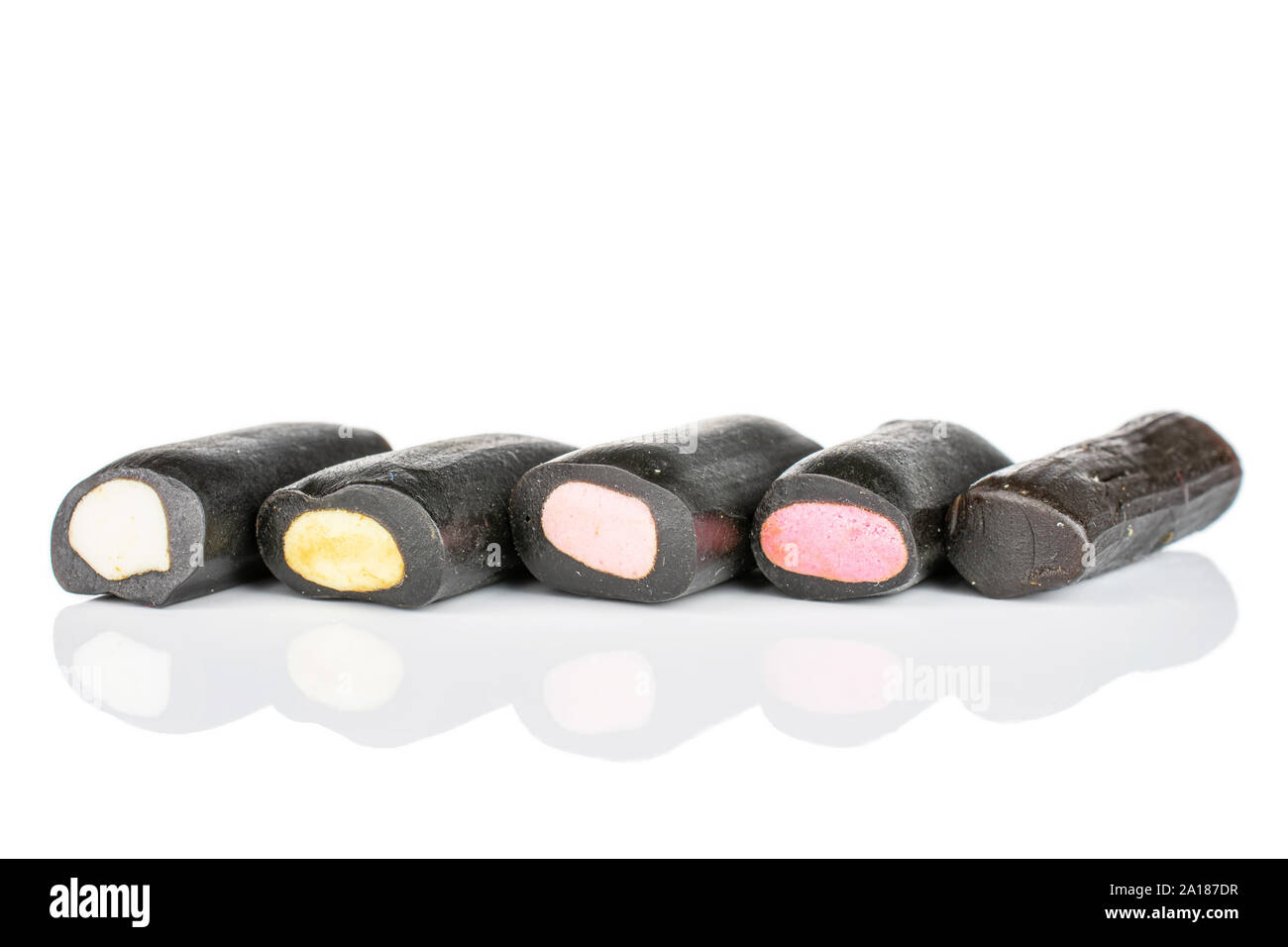 Group of five whole sweet black liquorice candy isolated on white ...