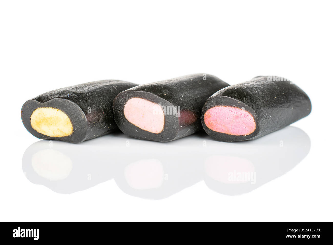 Group of three whole sweet black liquorice candy isolated on white ...
