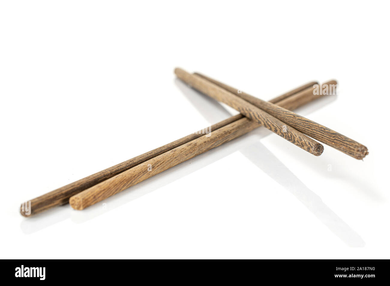 Group of four whole crossed asian brown chopsticks isolated on white ...