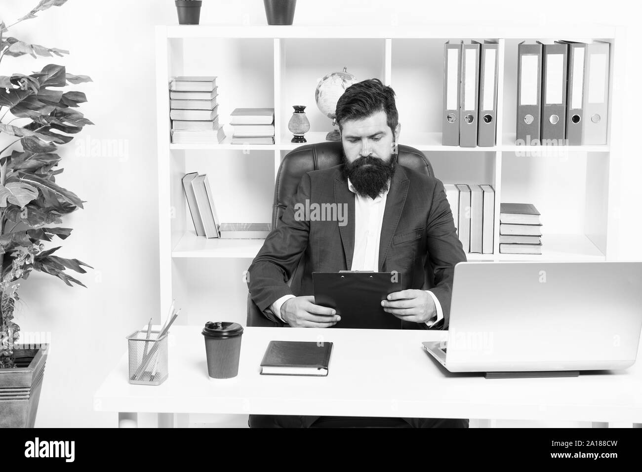 Check list. Man bearded hipster boss sit in leather armchair office ...