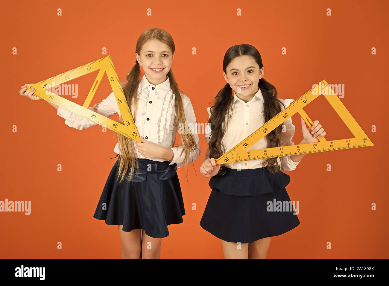 Education and school concept. School students learning geometry. Kids ...