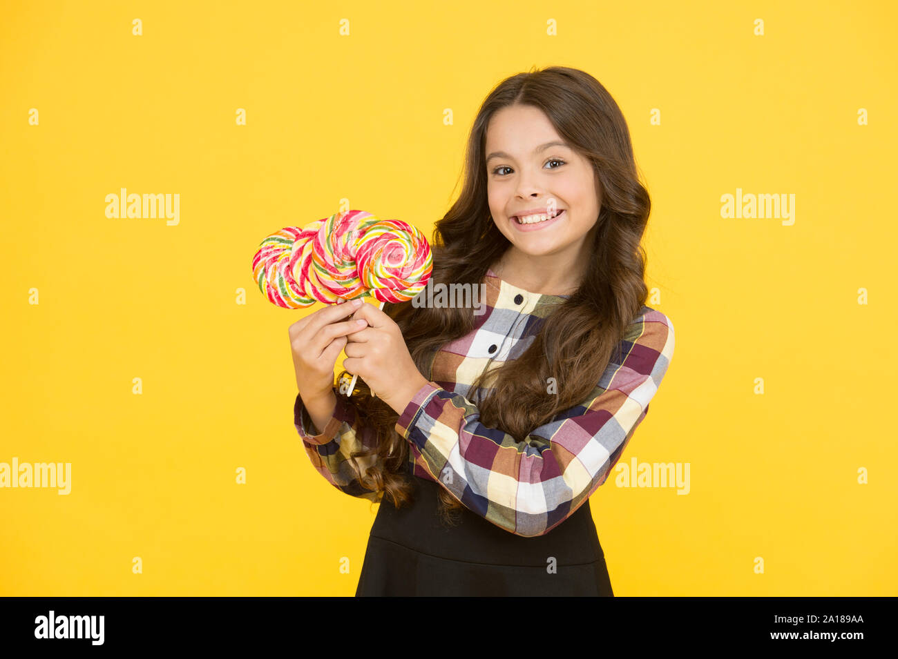 Sugar addiction. Happy kid with sweet candy. Kid child holding ...