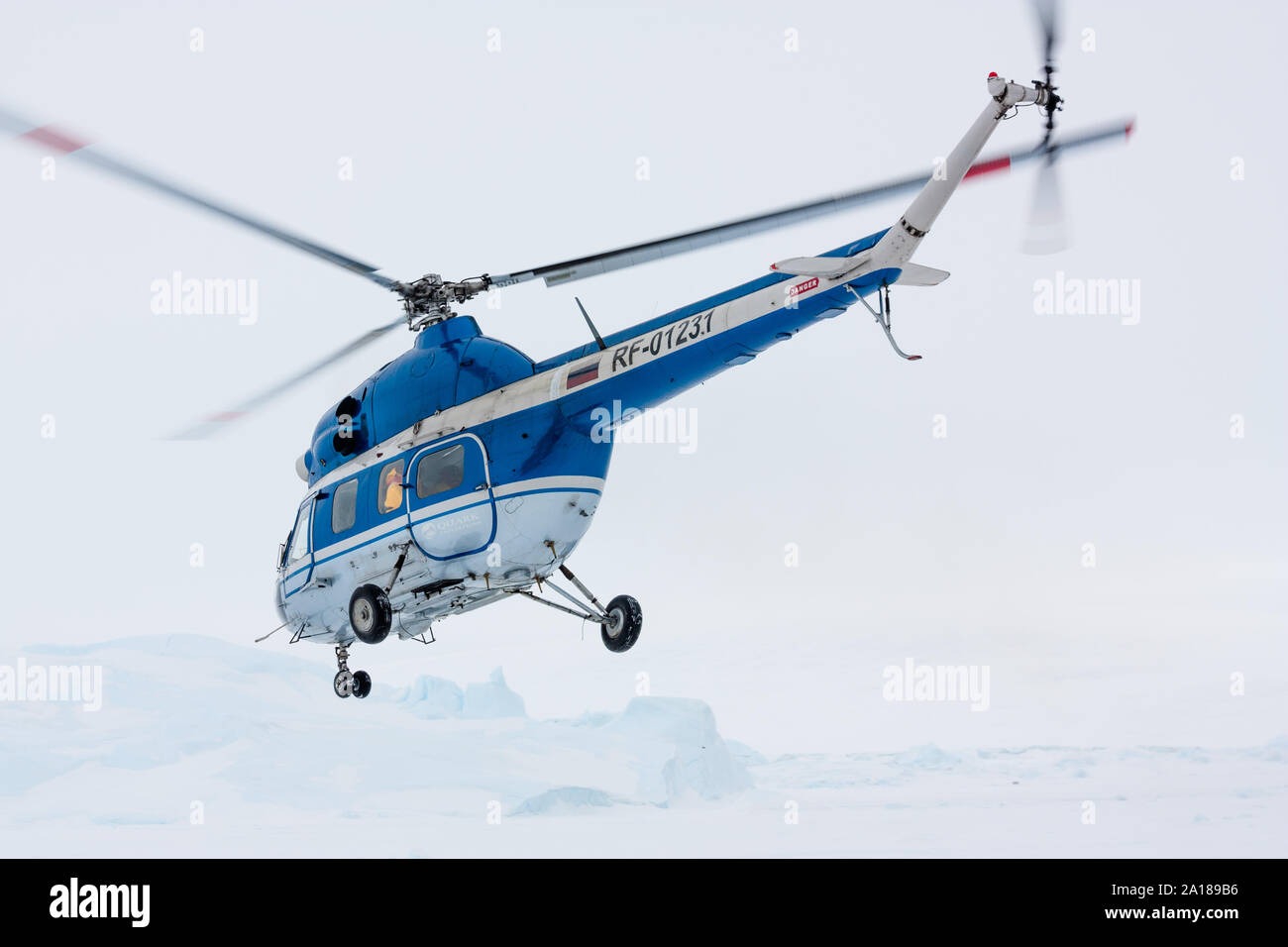 Expedition helicopter flying tourists in Snow Hill, Antarctica Stock ...