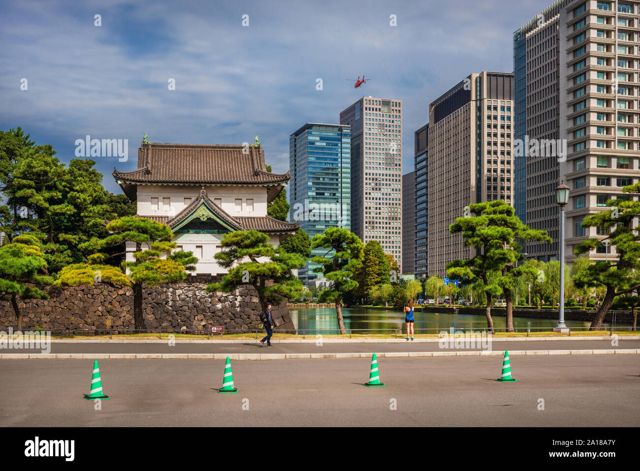 Tradition and Modernity in Japan. View of Imperial Palace old tower with the modern buildings ...