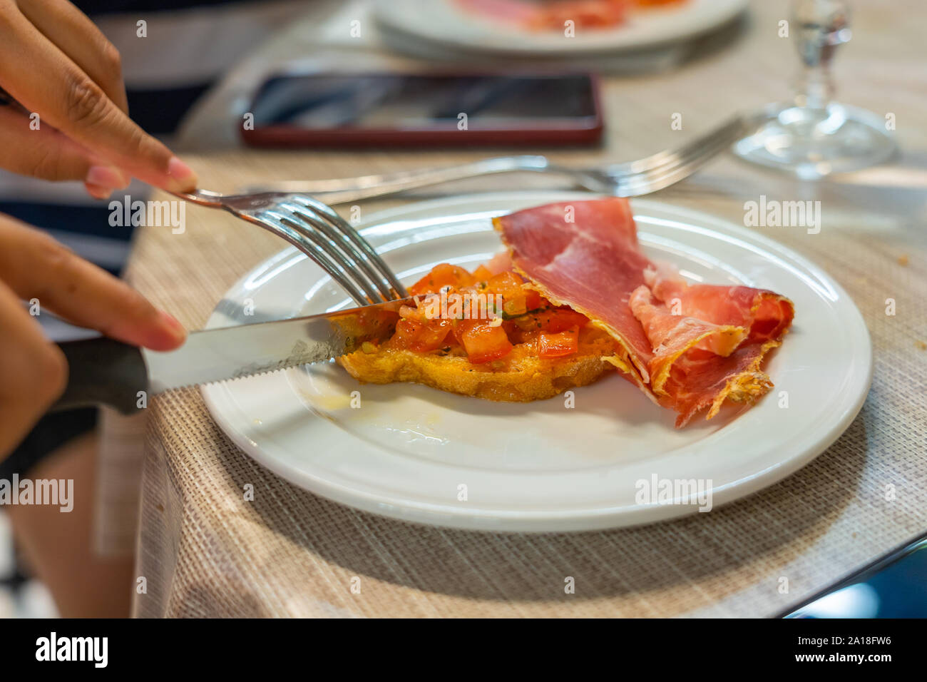 Human using knife and fork while having dinner with bacon Stock Photo ...