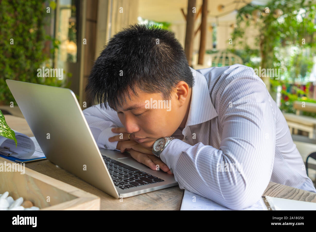 Tired businessman falling asleep while working on laptop Stock Photo ...
