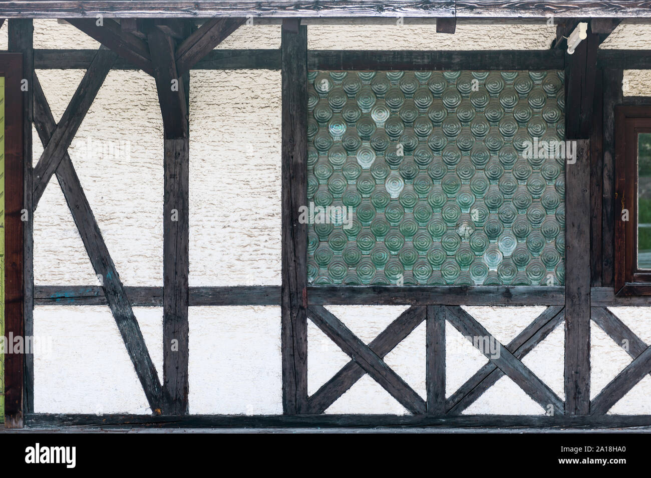 Frontal part view on an old half-timbered house with window from leaded ...
