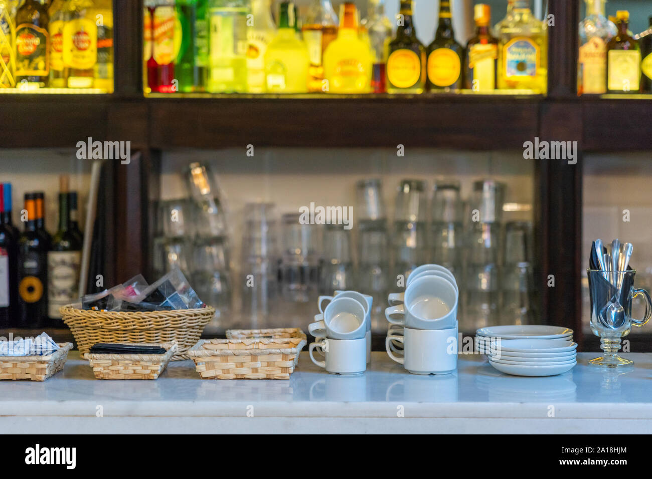 Stainless bar counter with mugs and beverage under tidy arrangement ...