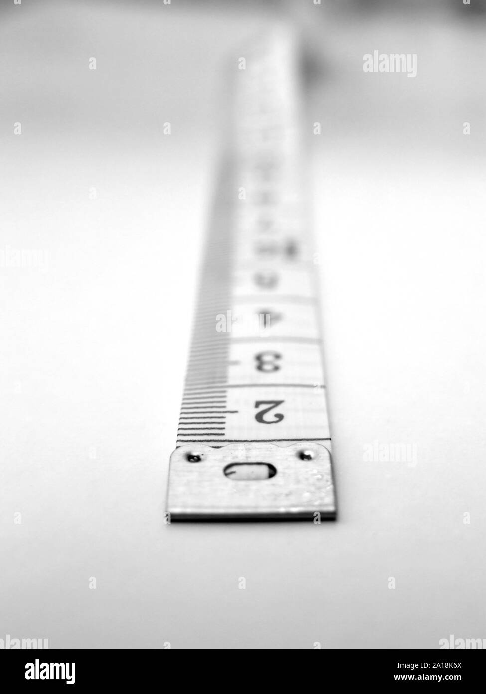 Measure with a ruler Black and White Stock Photos & Images - Alamy