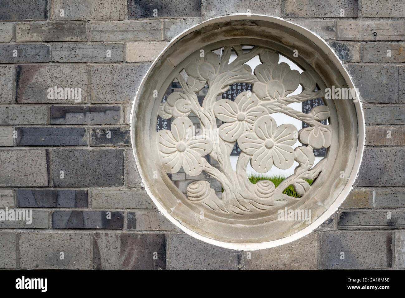 Traditional chinese stone fresco representing plants on a brick wall in ...