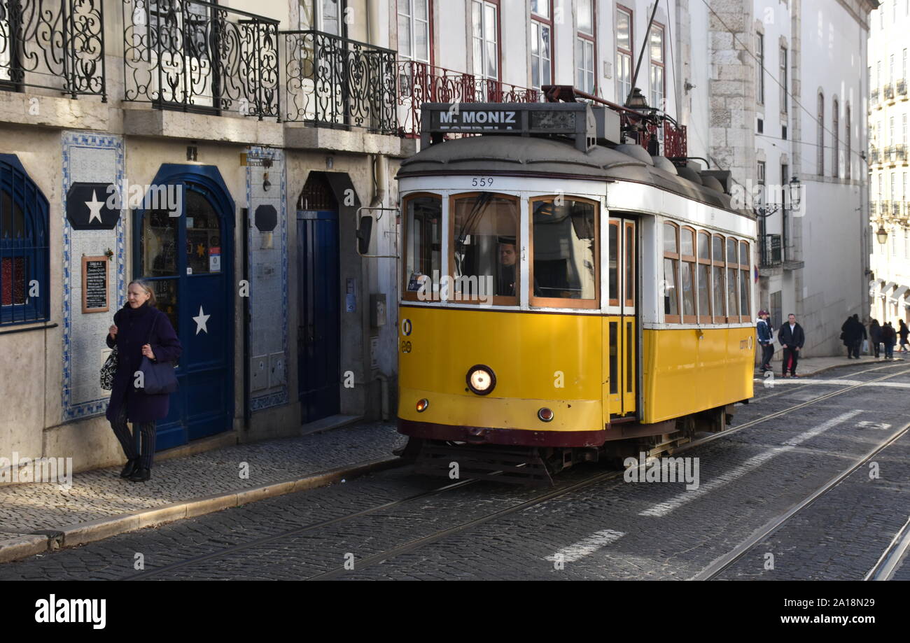 Famous Lisbon tram driving up the street Stock Photo - Alamy