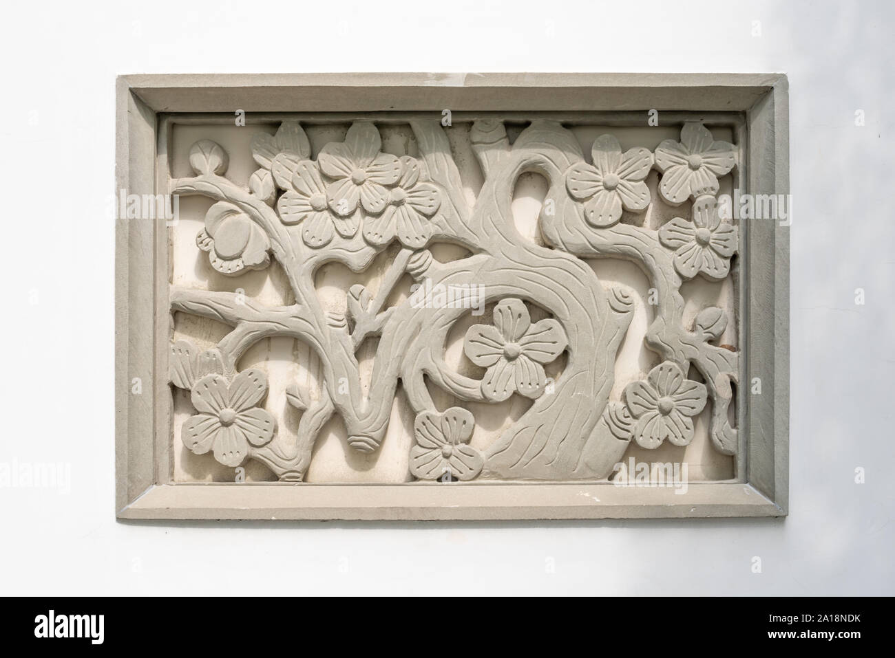 Traditional chinese stone fresco representing plants on a white wall in ...