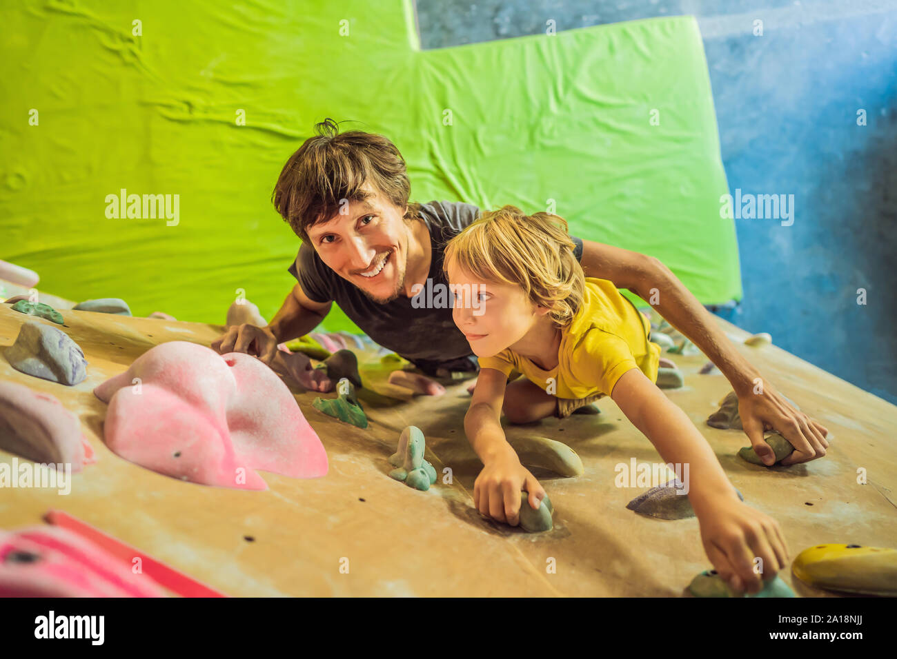 Dad and son at the climbing wall. Family sport, healthy lifestyle ...