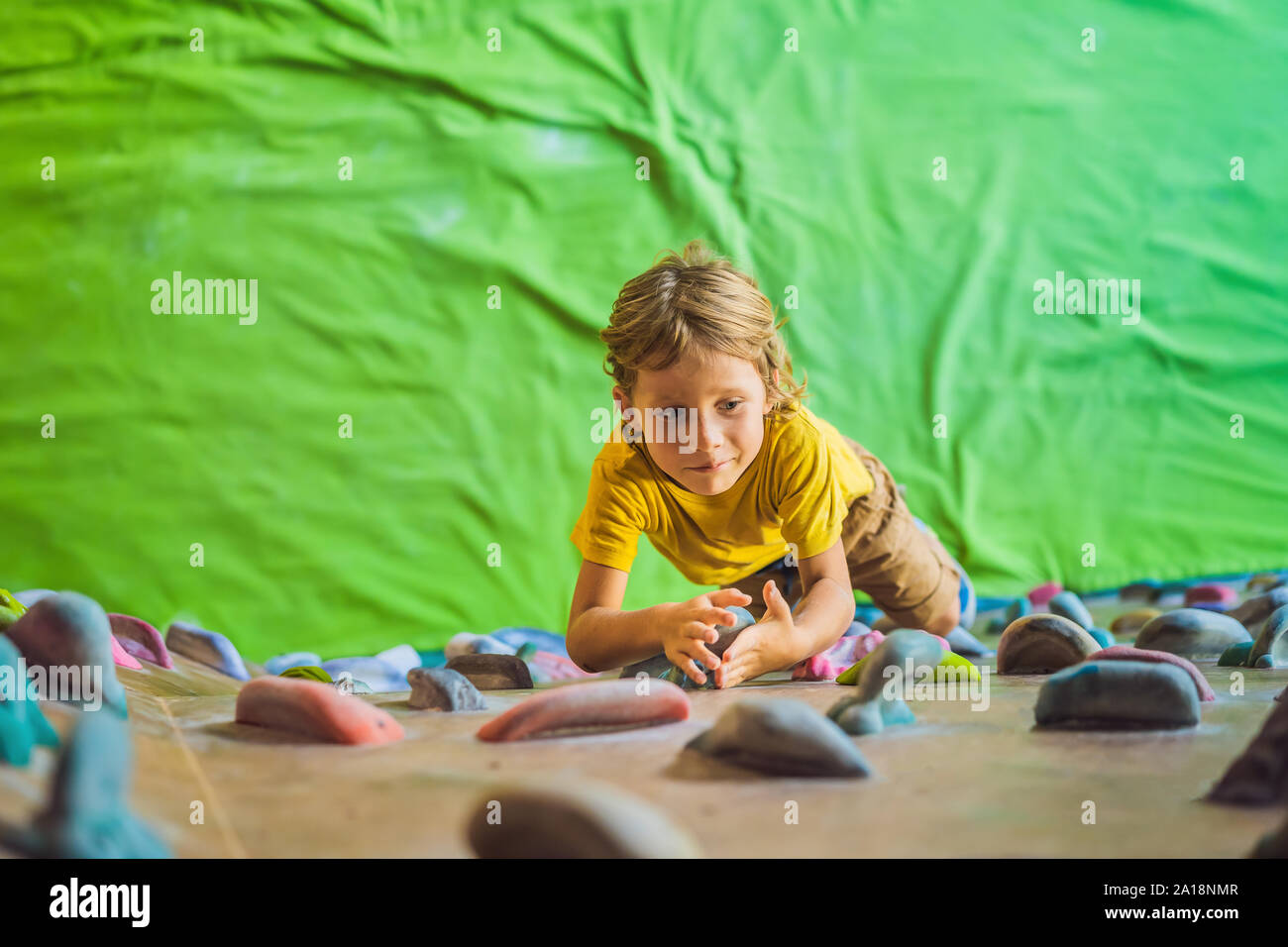 child climbing on a wall in an outdoor climbing center Stock Photo - Alamy