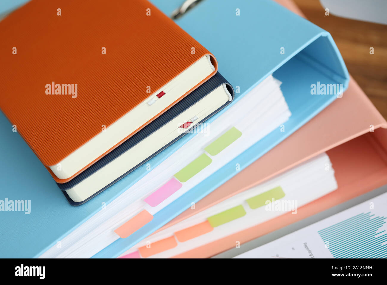 Stack of books with paper foder lie in office against Stock Photo - Alamy