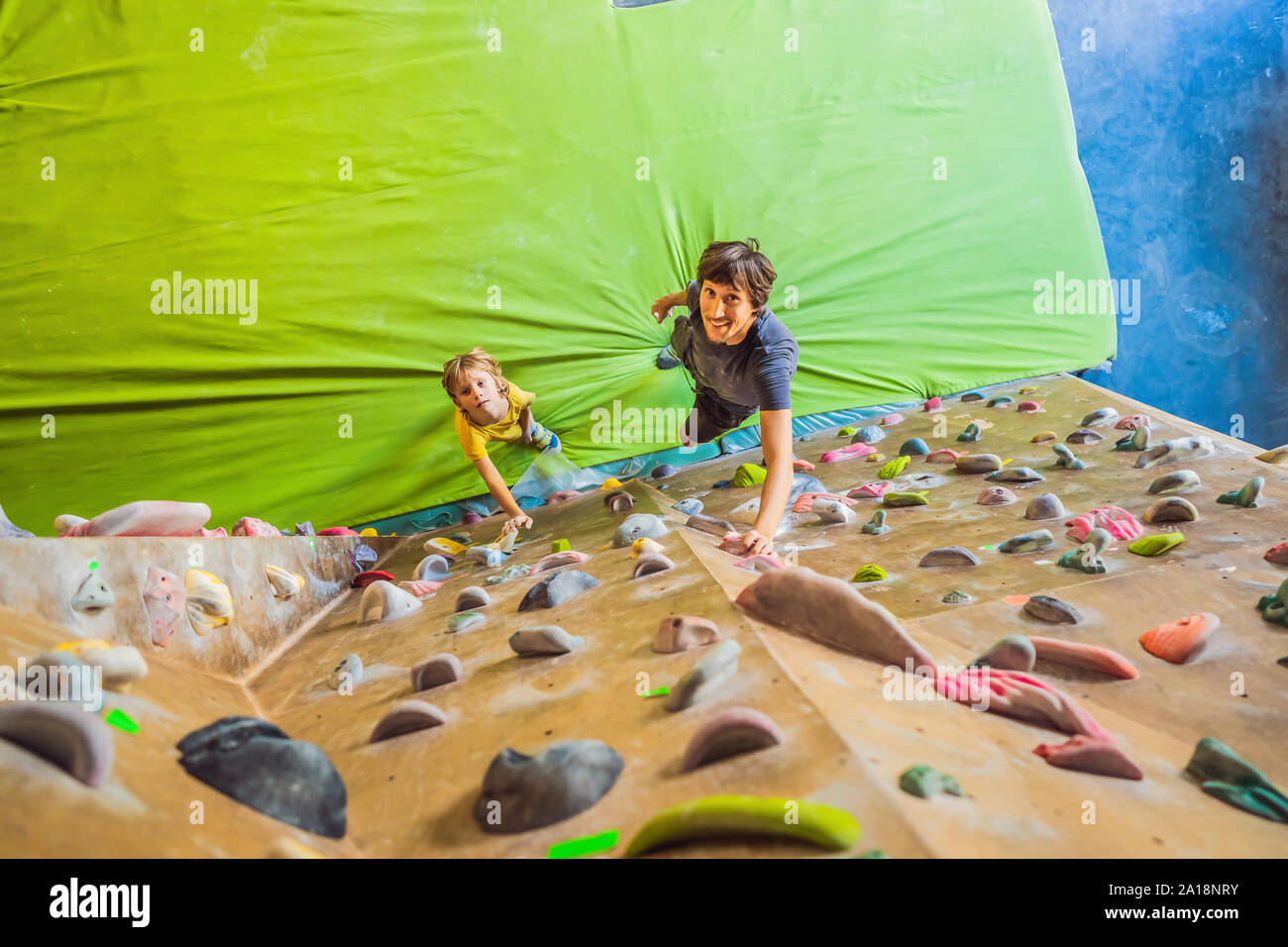 Dad and son at the climbing wall. Family sport, healthy lifestyle ...