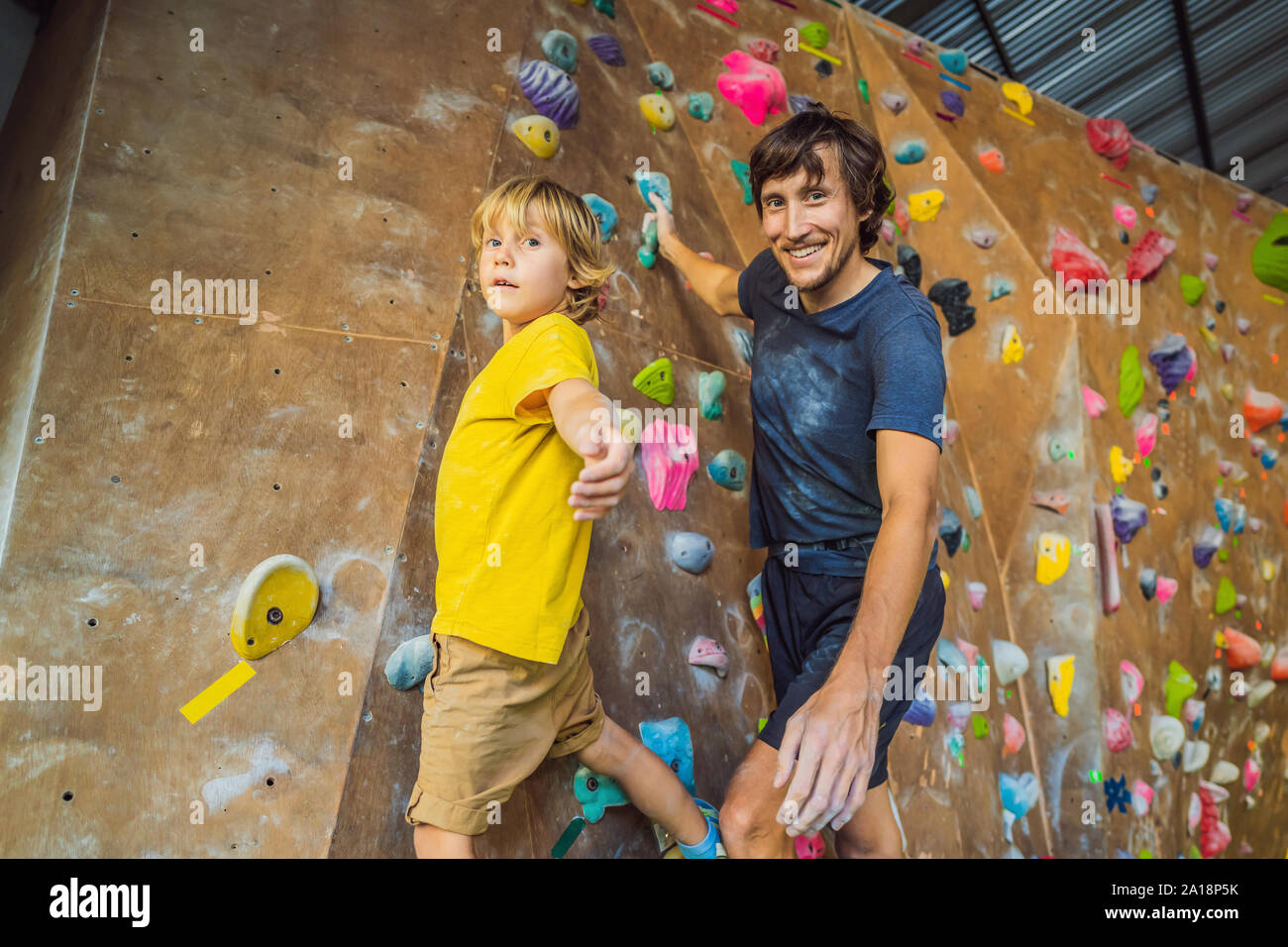 Dad and son at the climbing wall. Family sport, healthy lifestyle ...