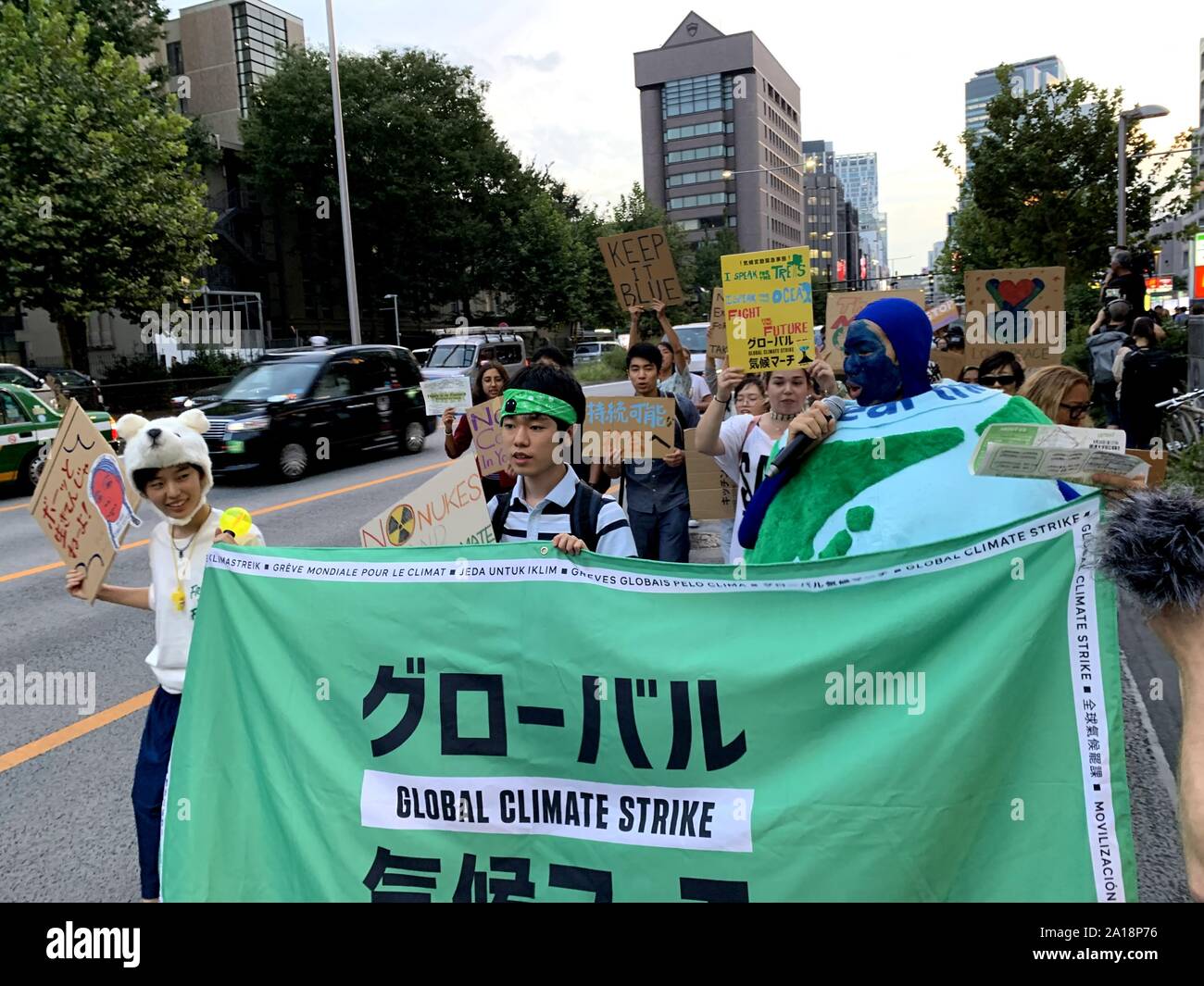People attend a protest march as part of the worlds largest climate ...