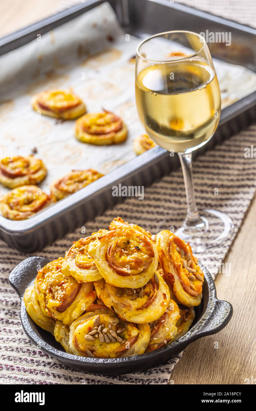 Rolls of puff pastry with ham bacon cheese sesame in dish Stock Photo ...