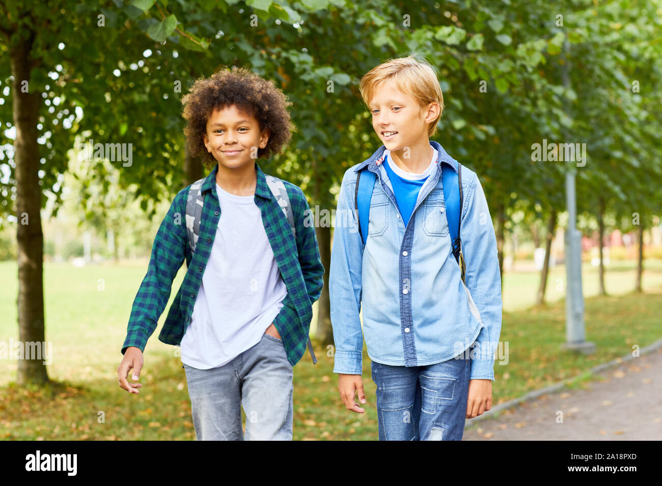 Two boys walking together school hi-res stock photography and images ...