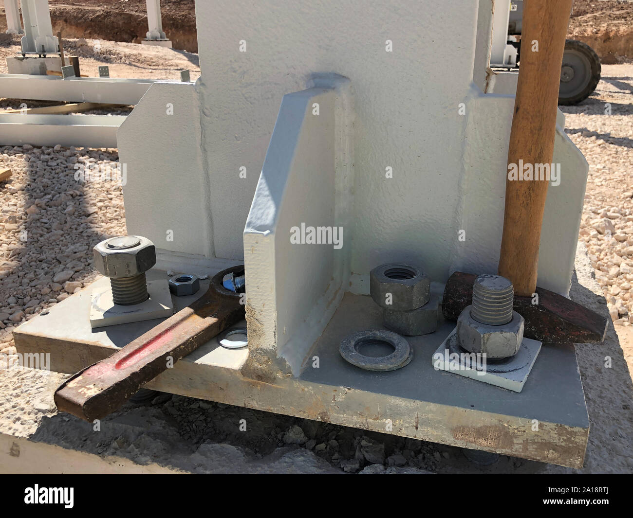 Metal pillar fastened to basement with anchor bolts and nuts ...