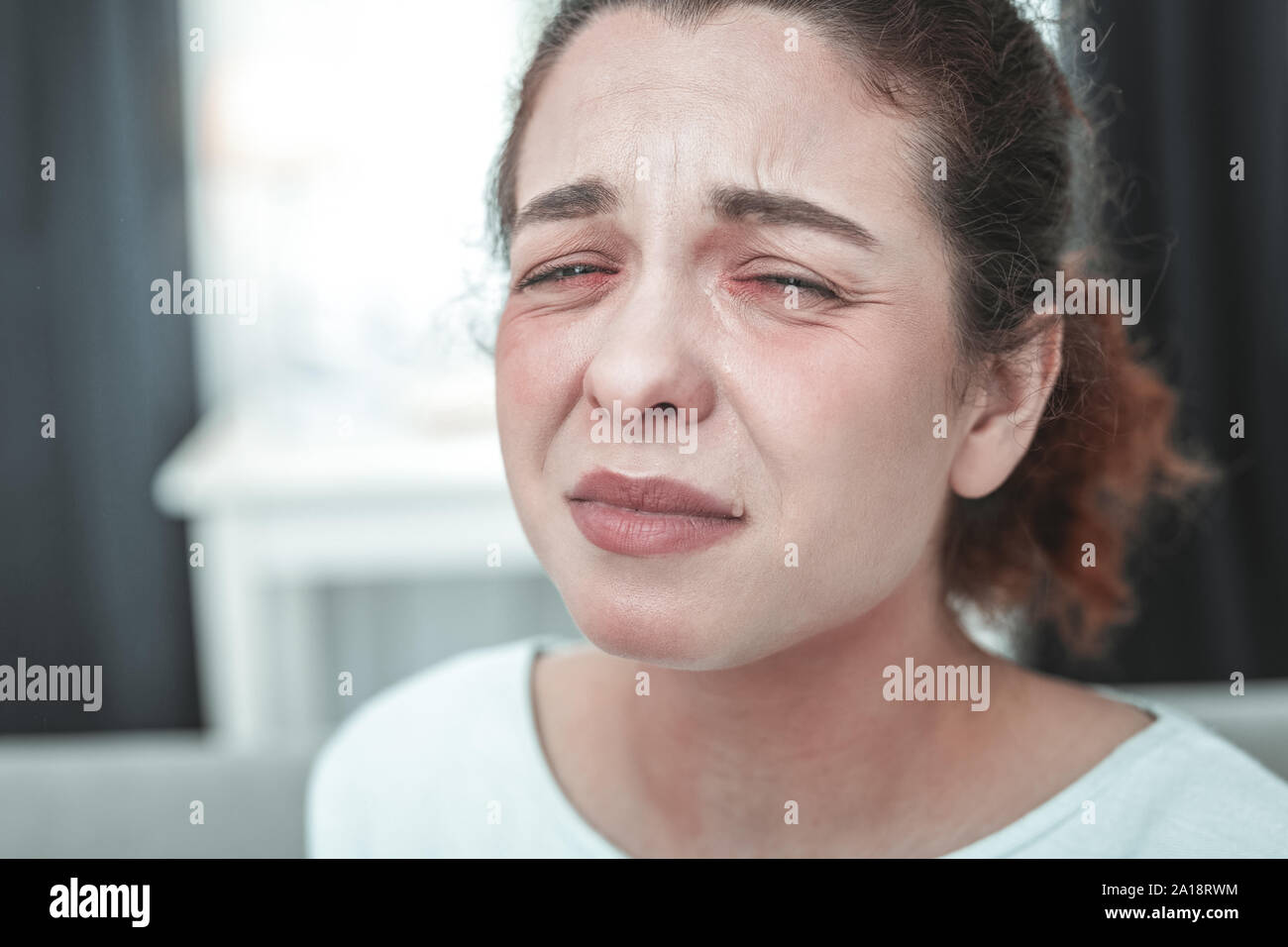 Mature woman with facial wrinkles crying having allergy Stock Photo - Alamy