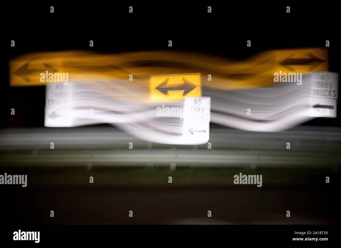 Distorted night view of traffic signs at aT intersection from drunk ...